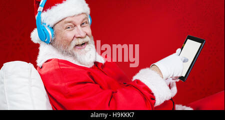 Portrait of Santa Claus listening to music on light background Stock ...