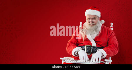 Composite image of santa claus typing on laptop against white ...