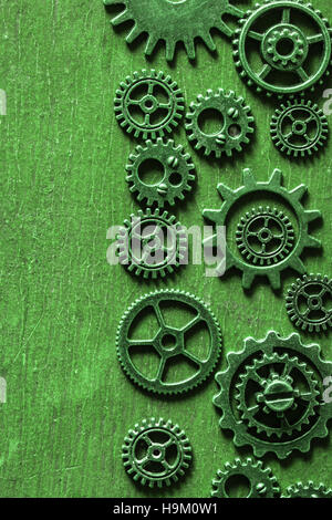 A Mechanism, green metallic gears and cogs at work on blue background ...