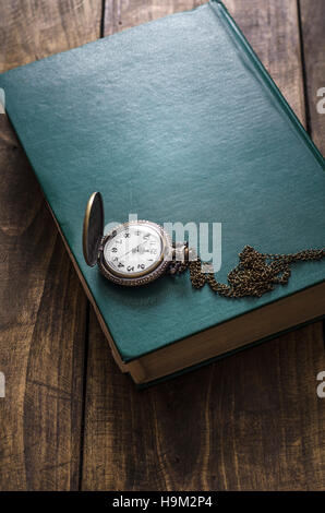 vintage pocket watch on an book Stock Photo - Alamy
