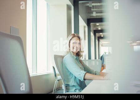 Businesswqoman working alone in office Stock Photo - Alamy
