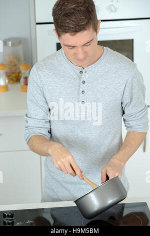 Chef by the stove stiring pasta in boiling water Stock Photo - Alamy