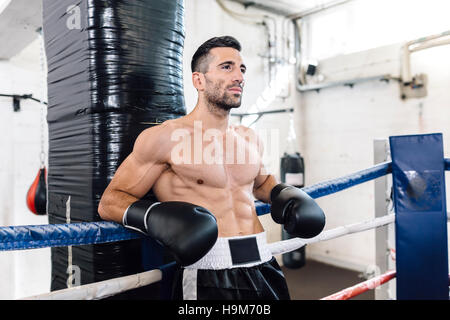 Boxer resting in boxing ring Stock Photo - Alamy