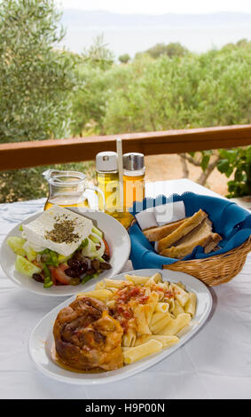Greek food classic veal stifada with pasta Greek salad crusty bread ...