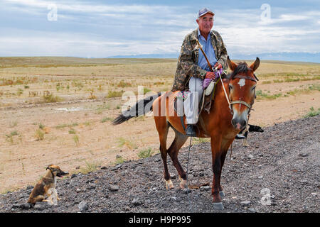 Portrait of a Kazakh man in traditional attire, with fox skin on wall ...