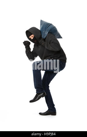 Burglar with bag on shoulder Stock Photo - Alamy
