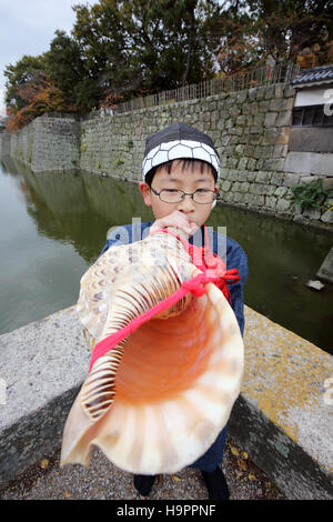 Samurai blowing into conch, Japan Stock Photo - Alamy