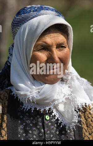 Portrait of an elderly Turkish woman with traditional bonnet sitting in ...