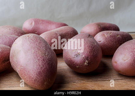 Red big imperfect potatoes on wooden cutting board from above Stock ...