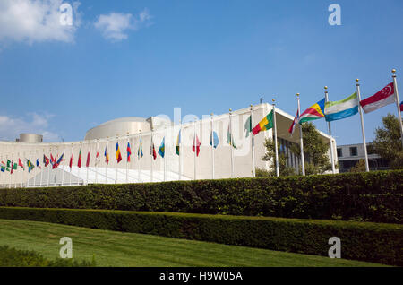 UN United Nations general assembly building with world flags flying in ...