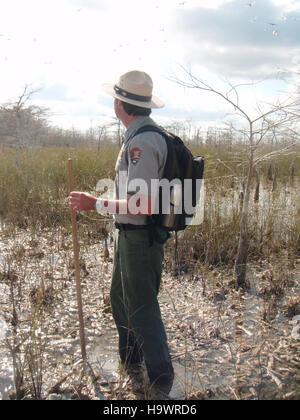 A park ranger educates visitors about the natural and cultural heritage ...