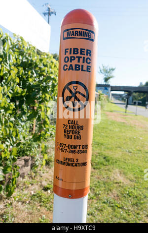 Sign warning that fiber optic cable is buried below Stock Photo ...