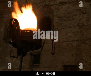 burning ancient oil lamp at the entrance of the medieval castle Stock ...