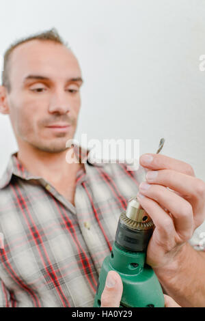 A man holding a driller Stock Photo - Alamy