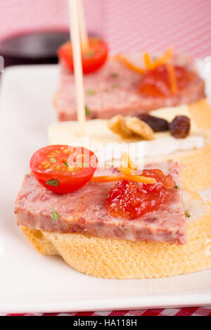 Serving of traditional Spanish pate tapa on a checkered tablecloth ...
