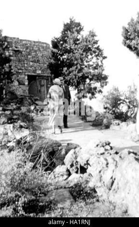 A historic photograph of architect Mary Colter reviewing blueprints for ...