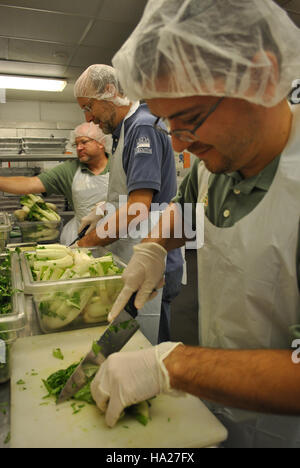 USDA employees prepare food at a central kitchen, demonstrating the ...