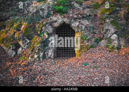 Entrance with iron gate to cave for the protection of bats as a project ...
