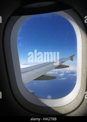 Travel concept. Wing of airplane flying above the clouds in trendy ...