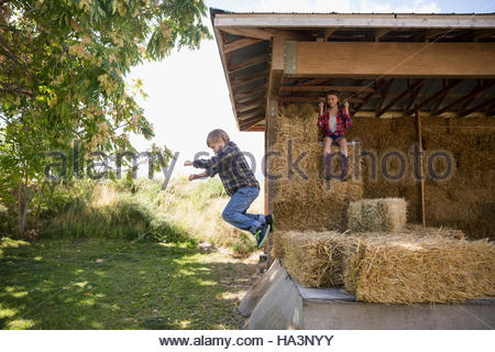 Boy and girl in a hay barn den Stock Photo: 4317356 - Alamy