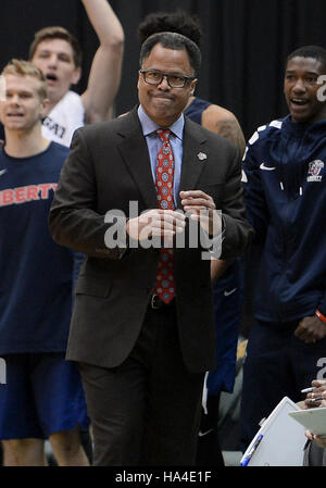 Liberty head coach Ritchie McKay, center left, hoists the trophy after ...