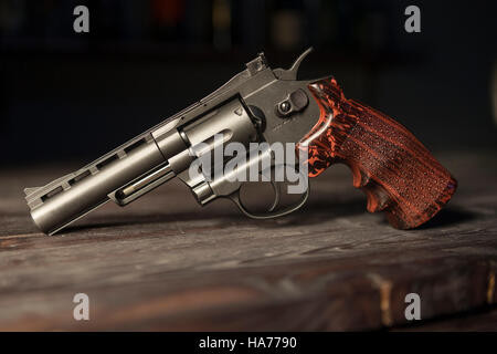 Revolver gun with ammunition on the wooden background Stock Photo - Alamy