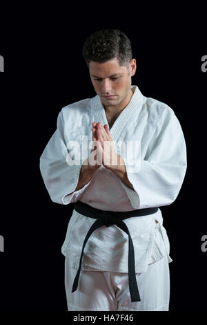 Karate player in prayer pose Stock Photo - Alamy