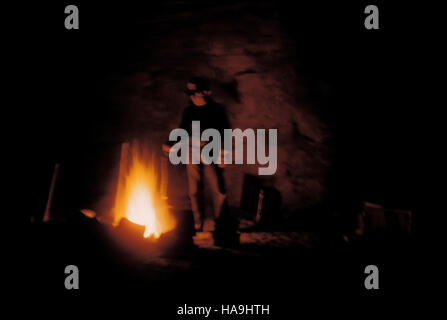 Bates Wilson tending fire Stock Photo - Alamy