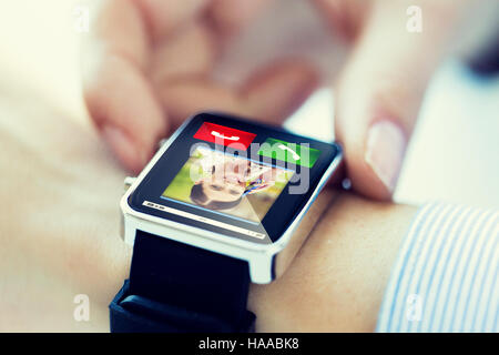 Smartwatch on hand, incoming call on screen, conversation via a smart ...