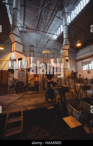 Glassblower working on marver table Stock Photo - Alamy