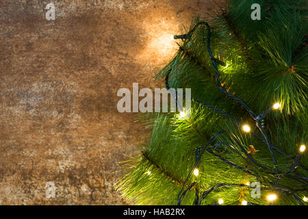 Christmas tree and lights on rusty background Stock Photo - Alamy