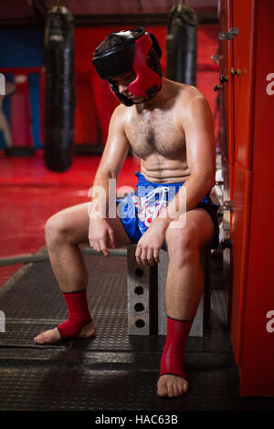 tired athletic sport man boxer resting in corner boxing ring after ...