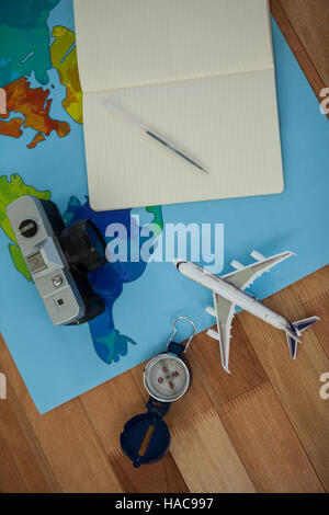 World map, compass, wooden airplane and passports isolated on white ...
