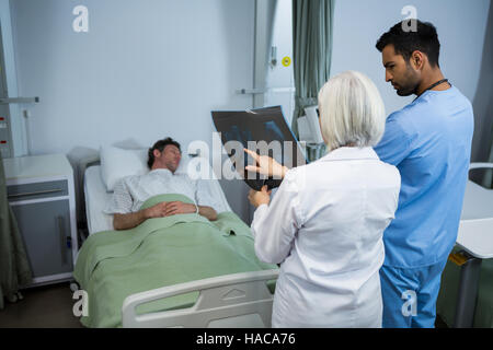 Doctor discussing over medical x-ray image with patient Stock Photo - Alamy
