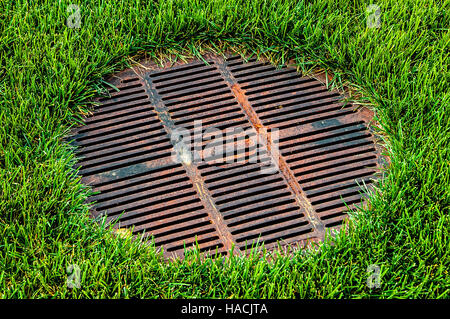 Sewer manhole on a green lawn Stock Photo - Alamy