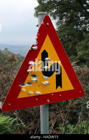 A road sign in the mountains of Crete with large bullet holes Stock ...