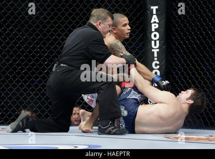 Referee in an MMA cage fight talks to fighters before the match begins ...