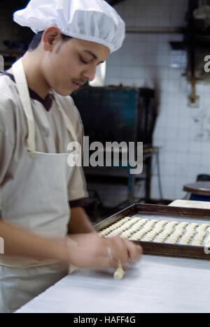 A cook at Al-Andalos Sweets in Aleppo in northern Syria preparing ...
