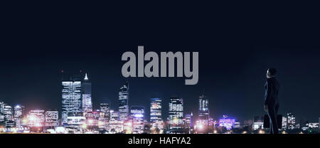 Businesswoman viewing night glowing city Stock Photo - Alamy
