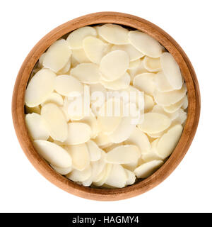 Sliced almond nuts in a wooden bowl and wooden spoon with cutting board ...