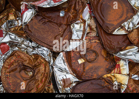Old crushed rusty tin can on dusty background Stock Photo - Alamy