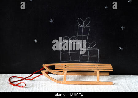 Christmas gifts on the sled abstract concept Stock Photo - Alamy