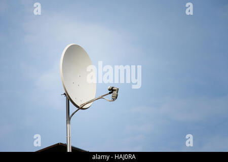Satellite dish and home TV antenna mounted on the roof. In the evening ...