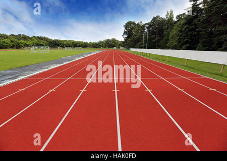 blue racing tracks and grass field Stock Photo - Alamy