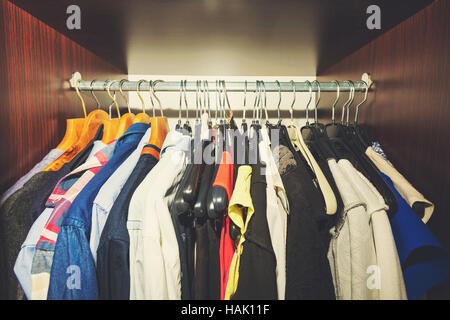 Colorful clothes hanging in wardrobe Stock Photo - Alamy