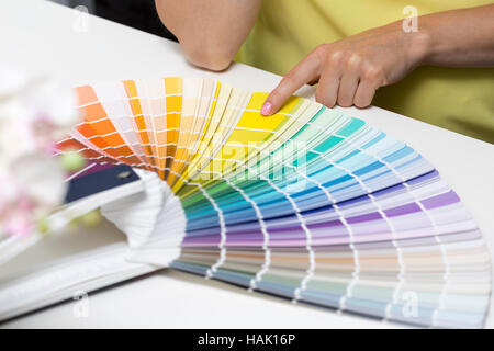 Color wheel palette for choosing paint tone. Various colors on wooden ...