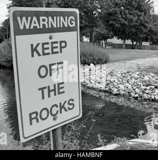 A keep off the rocks warning sign Stock Photo - Alamy