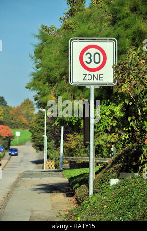 Road sign Tempo 30 Zone, one-family house in the background, Germany ...