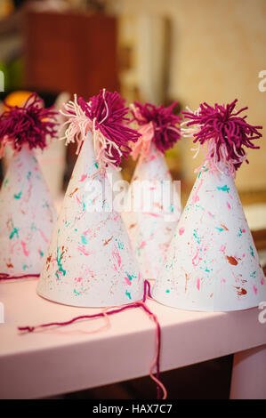A group of bright and colorful birthday caps isolated on a white ...