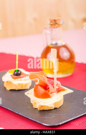 Traditional Spanish pincho style serrano ham tapa Stock Photo - Alamy